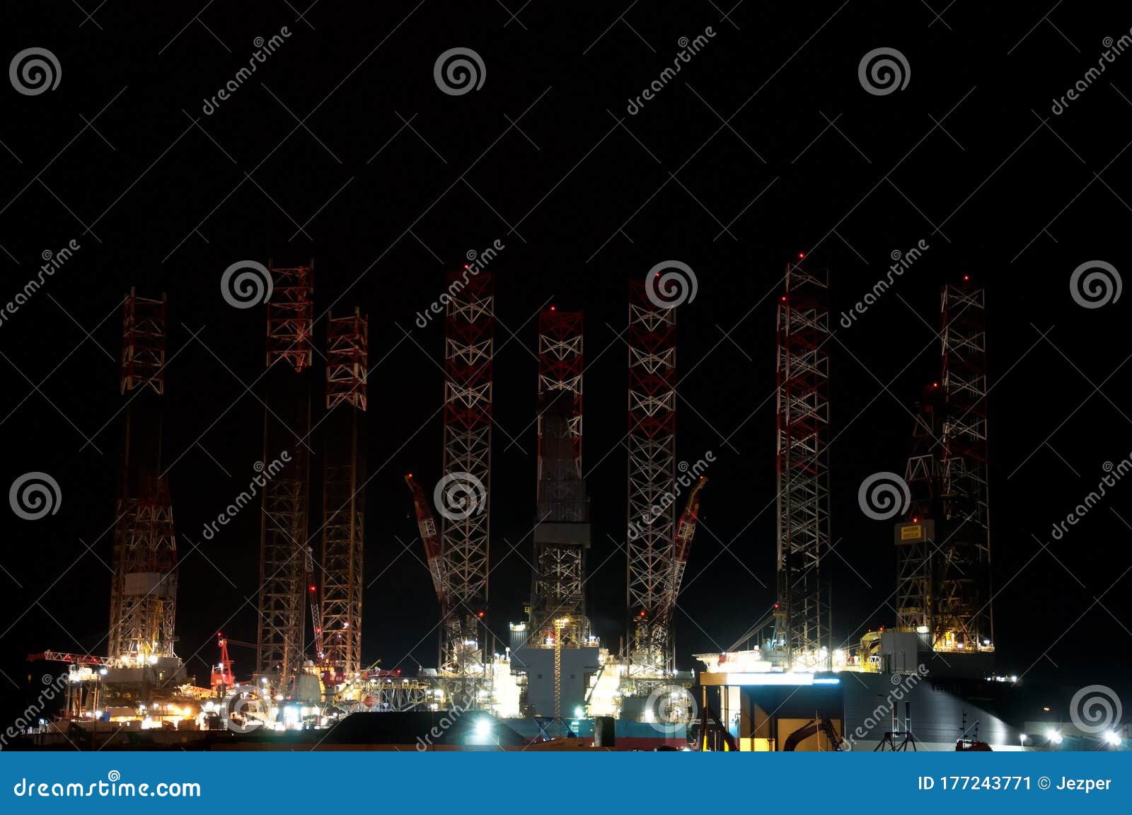 Oil rig platforms at night stock image. Image of ocean - 177243771
