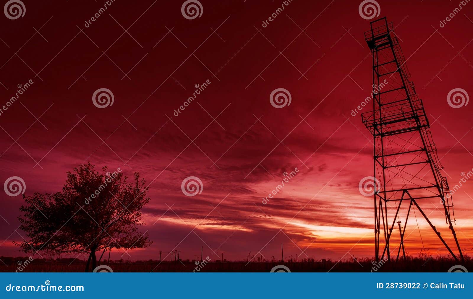 Oil Rig Structure and Lonely Tree Profiled on Dramatic Sunset Sky Stock ...