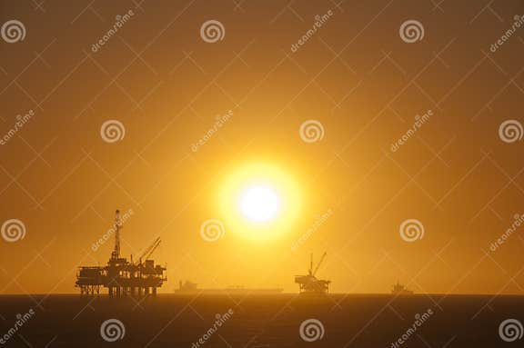 Oil rigs at sunset. stock photo. Image of huntington - 17024636