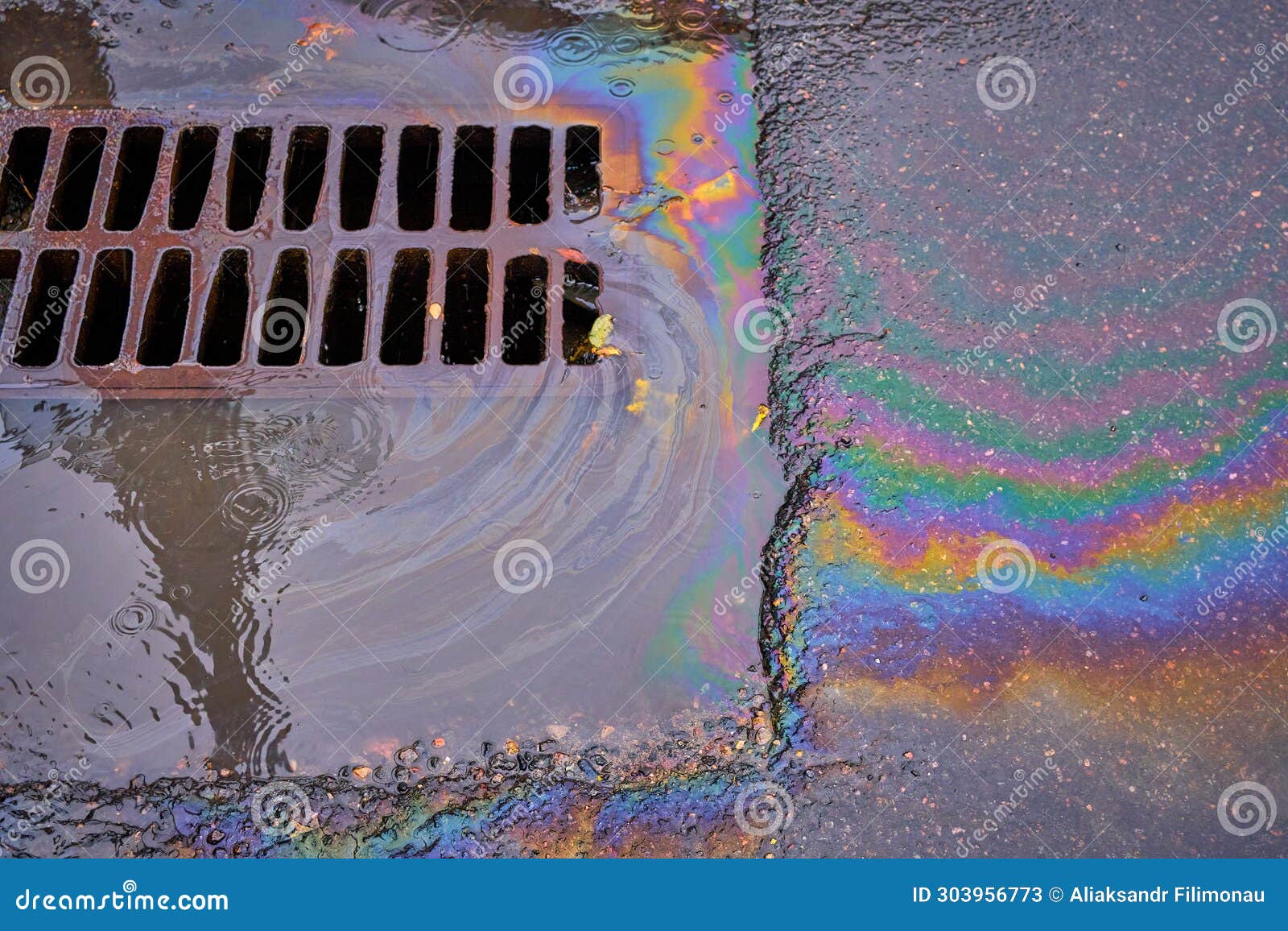An Oil Slick Against the Backdrop of an Asphalt Road Flows into a Storm ...
