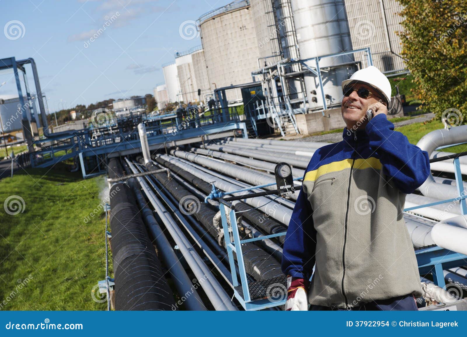 Oil Worker Talking in Phone Inside Refinery Stock Photo - Image of ...