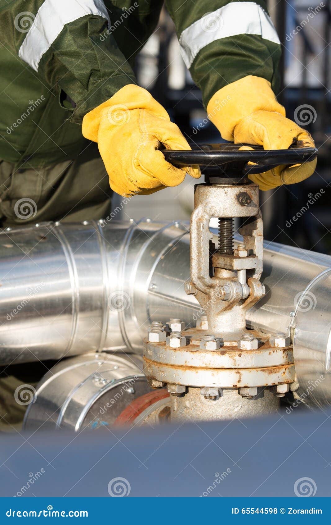 Oil worker turning valve stock photo. Image of crude - 65544598