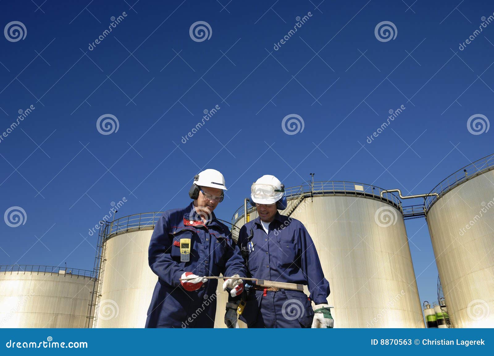 Oil Workers and Refinery Tanks Stock Image - Image of factory ...