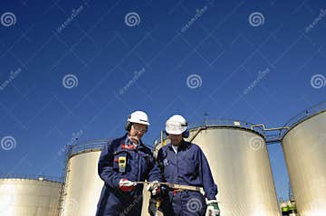 Oil Workers and Refinery Tanks Stock Image - Image of factory ...