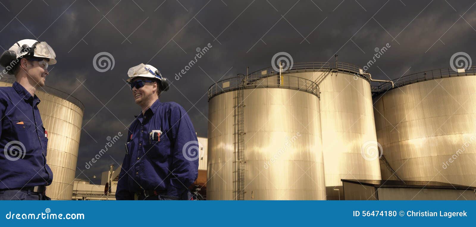 Oil Workers and Tanks at Sunset Stock Photo - Image of pollution ...