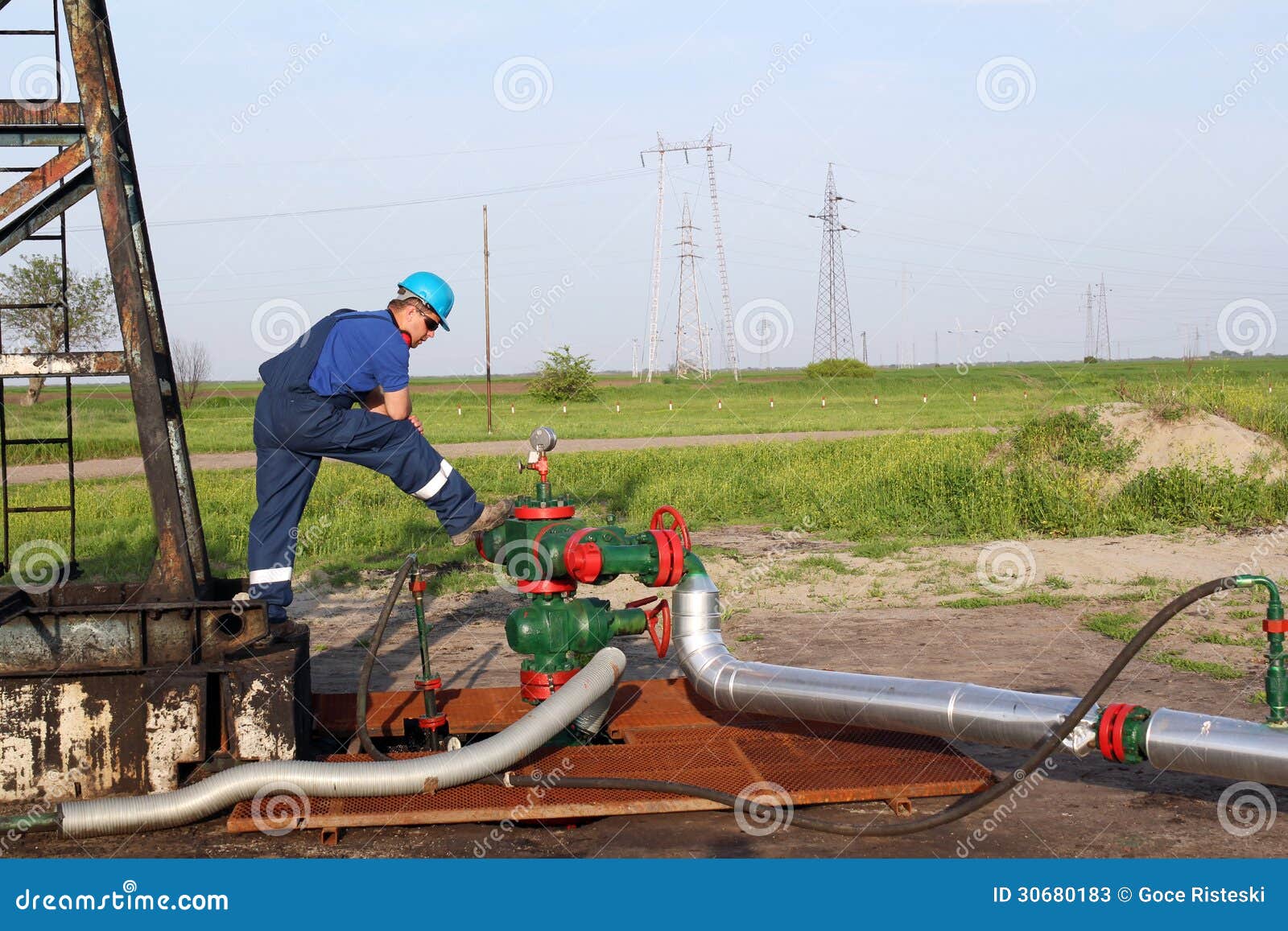 Oilfield with worker stock image. Image of helmet, field - 30680183