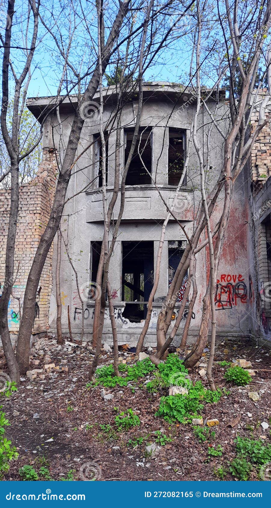 An Old Abandoned Mansion with Broken Windows and Graffiti on the Walls ...