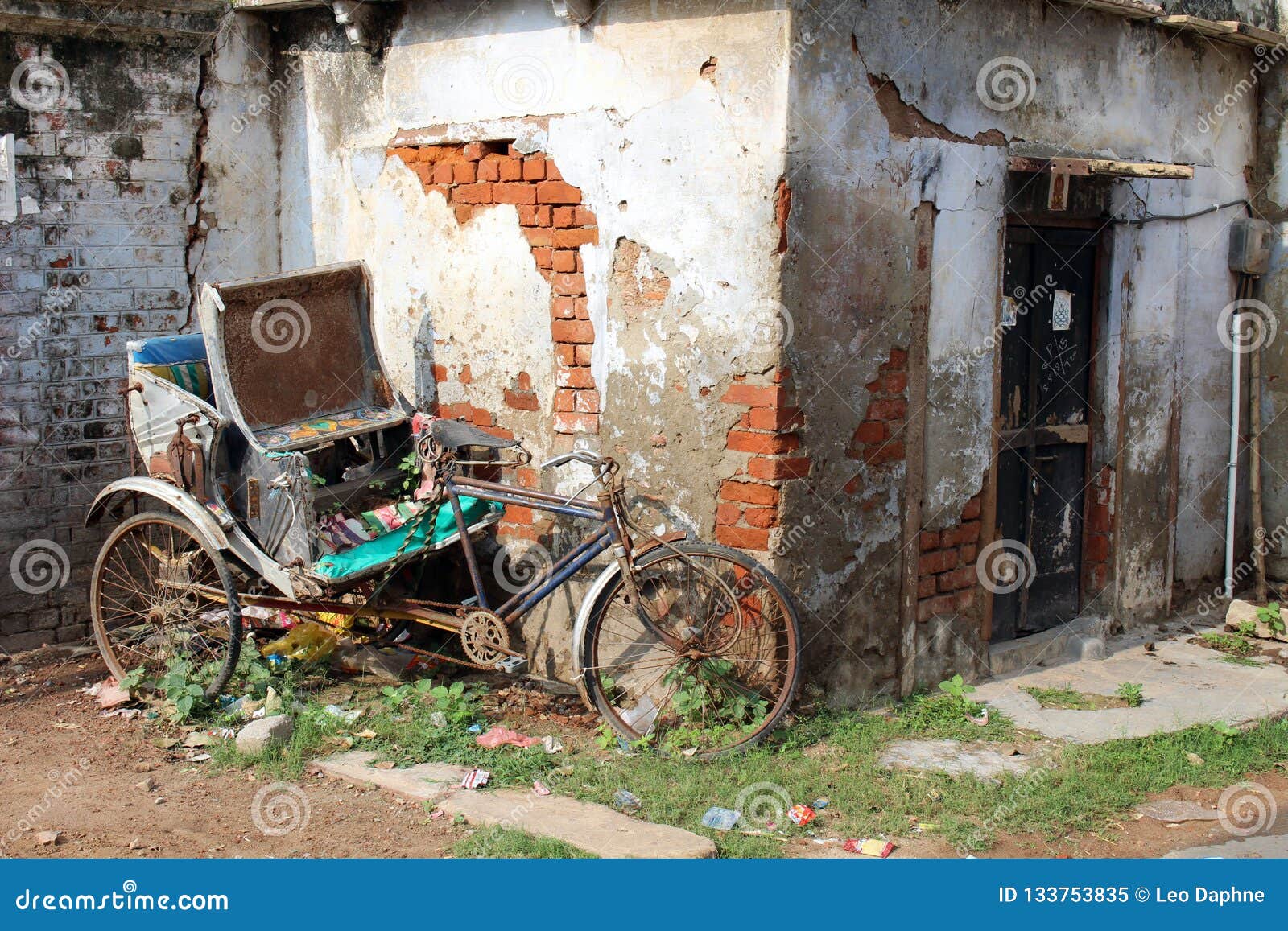 The Old and Abandoned Rickshaw and Bicycle in Front of a Gate in Stock ...