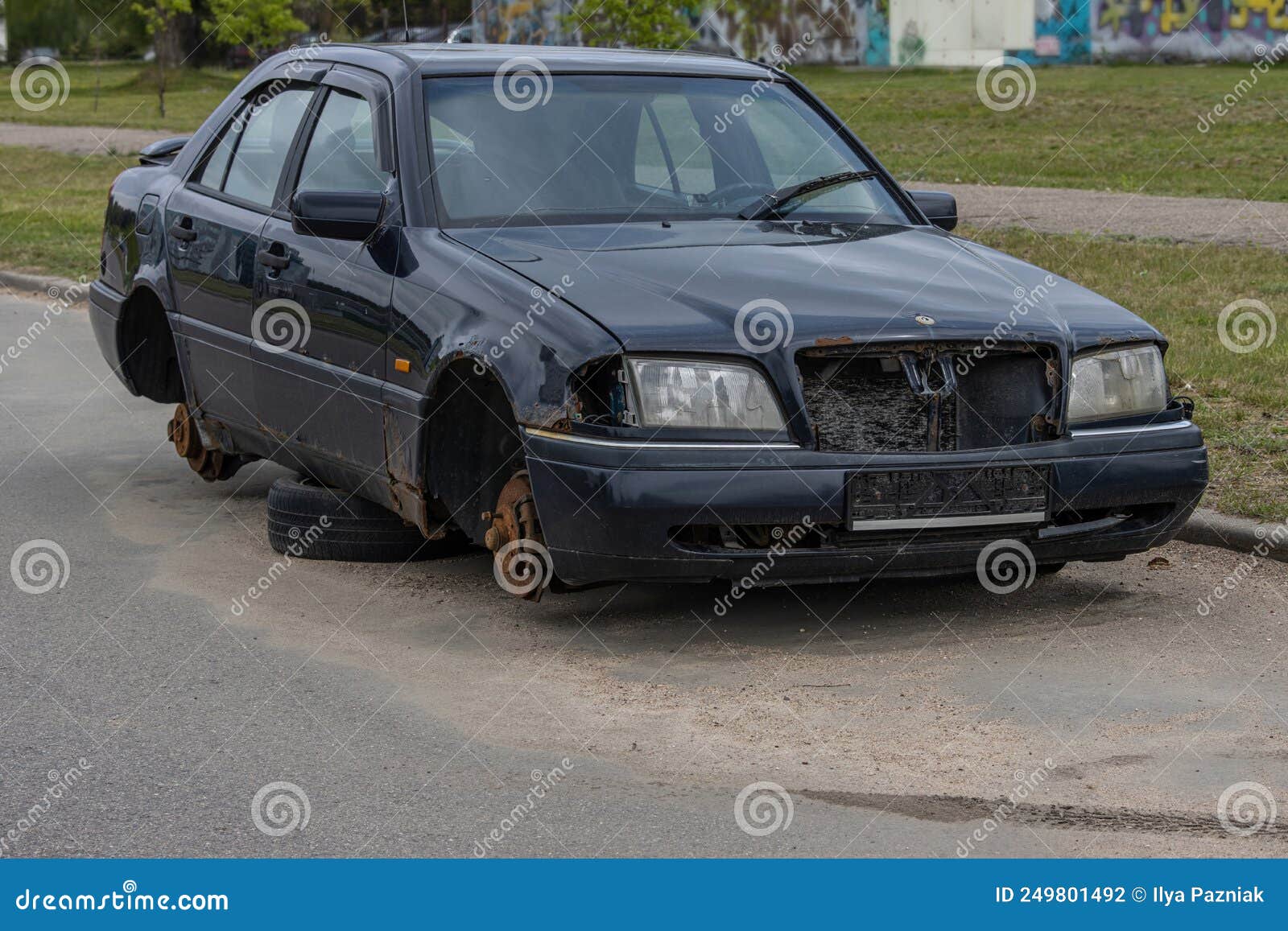 Old Abandoned Rusty Car without License Plates and Wheels on the Side ...