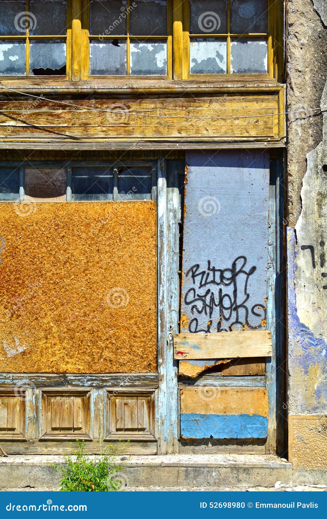 An Old Abandoned Shop Painted Blue And White With Empty Store Front ...