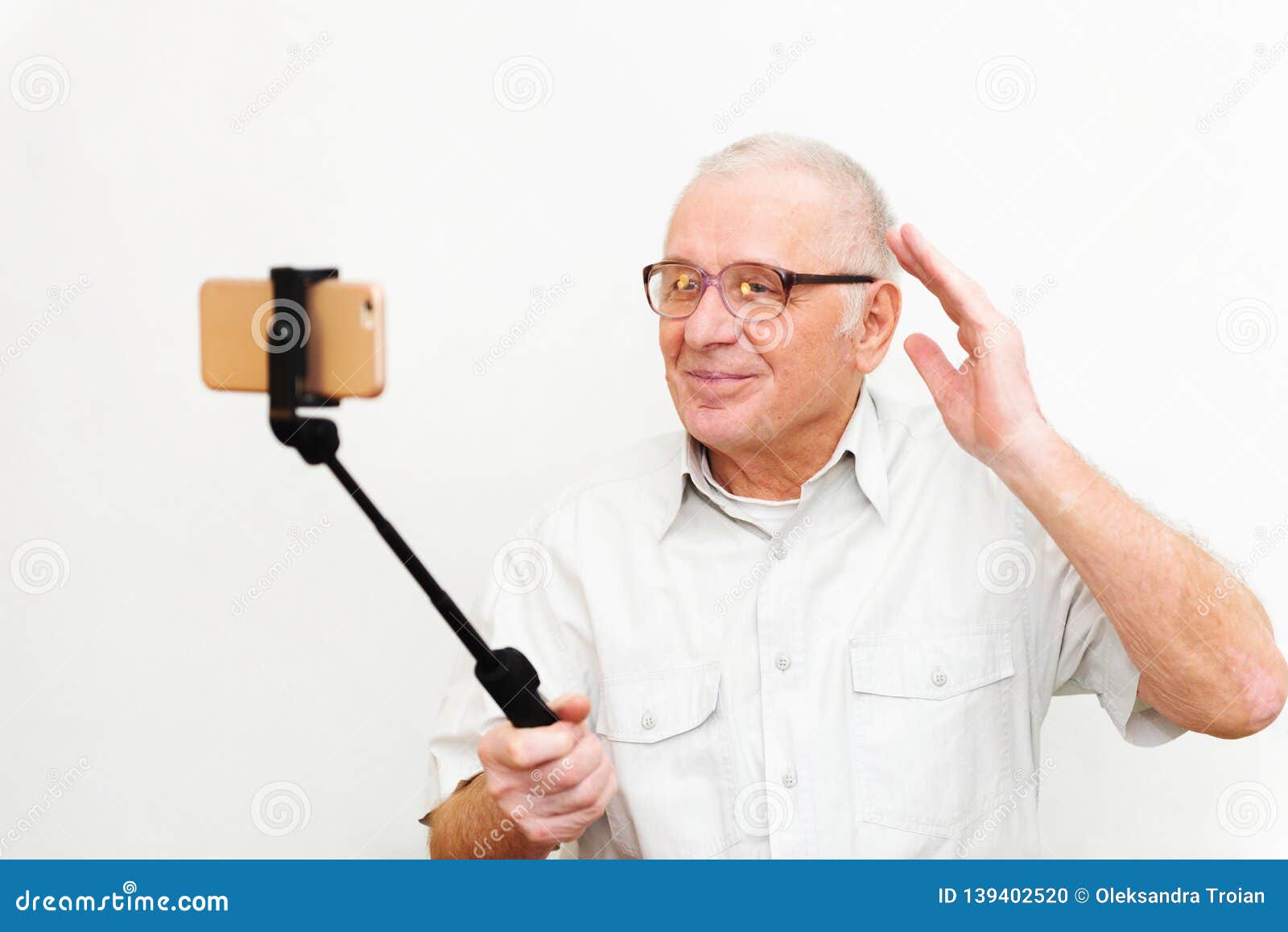 Old Active Man Taking Selfie with Mobile Phone Isolated on Grey ... Old Active Man Taking Selfie with Mobile Phone Isolated on Grey ...