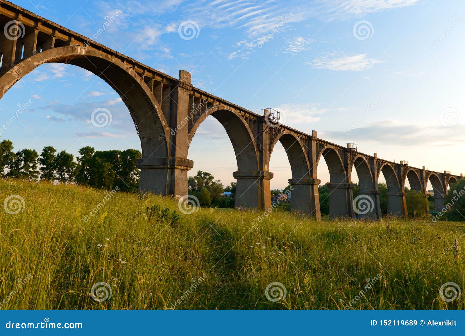 Old Arch Bridge Over a Gully Overgrown with Grass in the Evening Stock ...