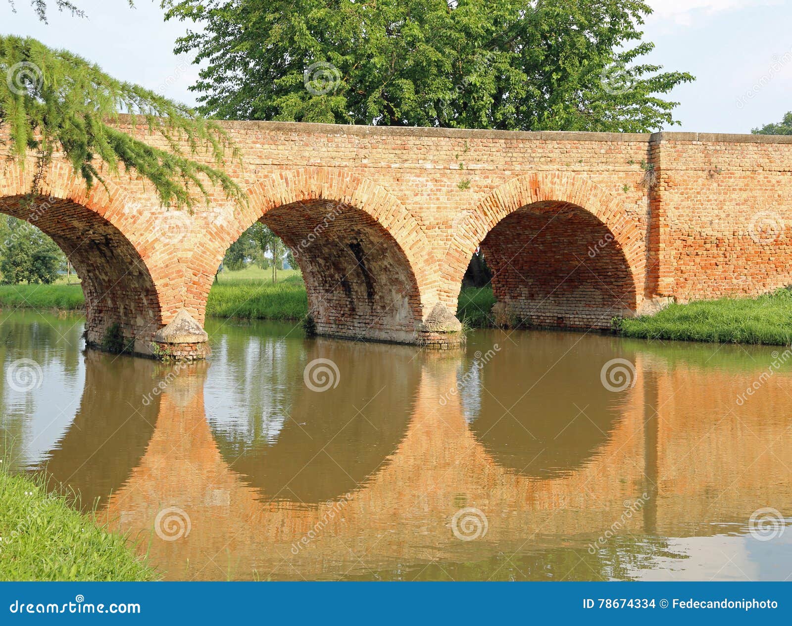 Old Arched Bridge Made of Red Bricks with the River Stock Photo - Image ...