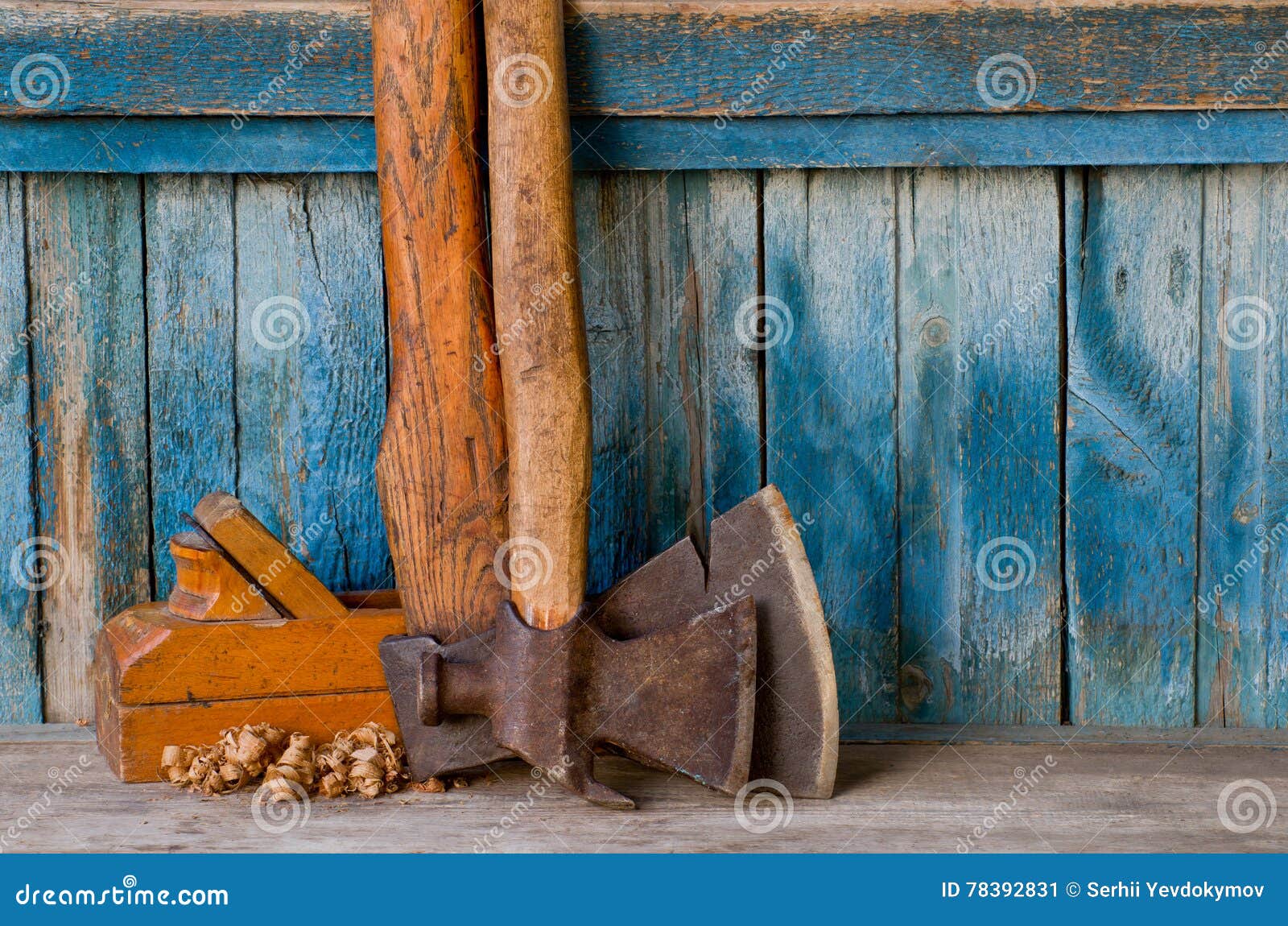 Old Ax, Pickaxe, Wooden Plane And Chips On A Background Of The Old Wall ...