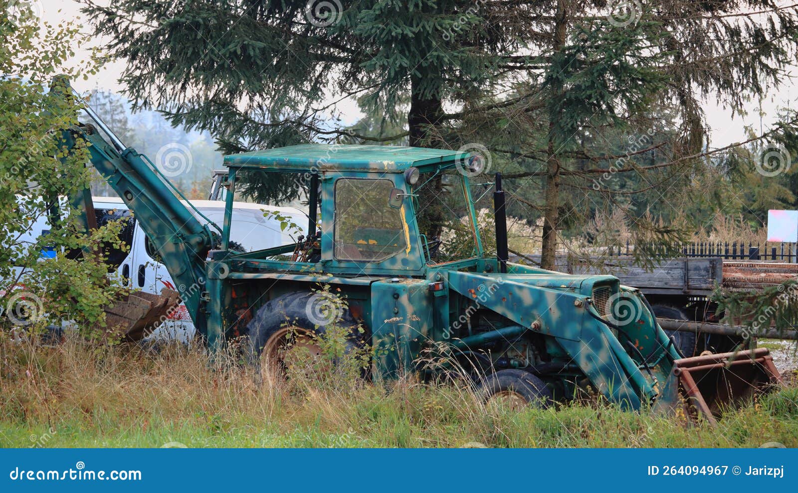 An Old Backhoe Loader Standing Somewhere among the Greenery Stock Image ...