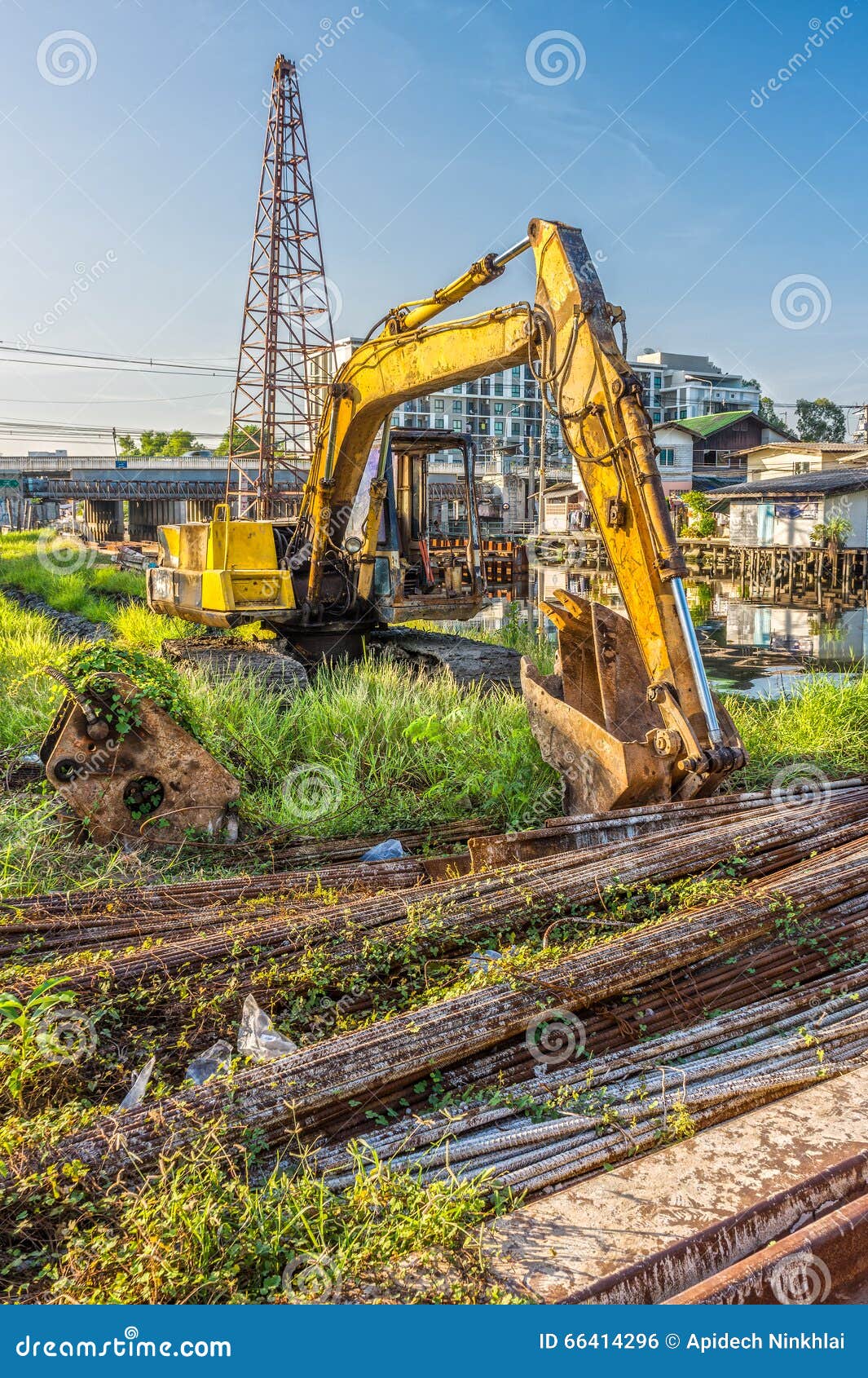 Old Backhoe and Steel Rods at Construction Site Stock Photo - Image of ...