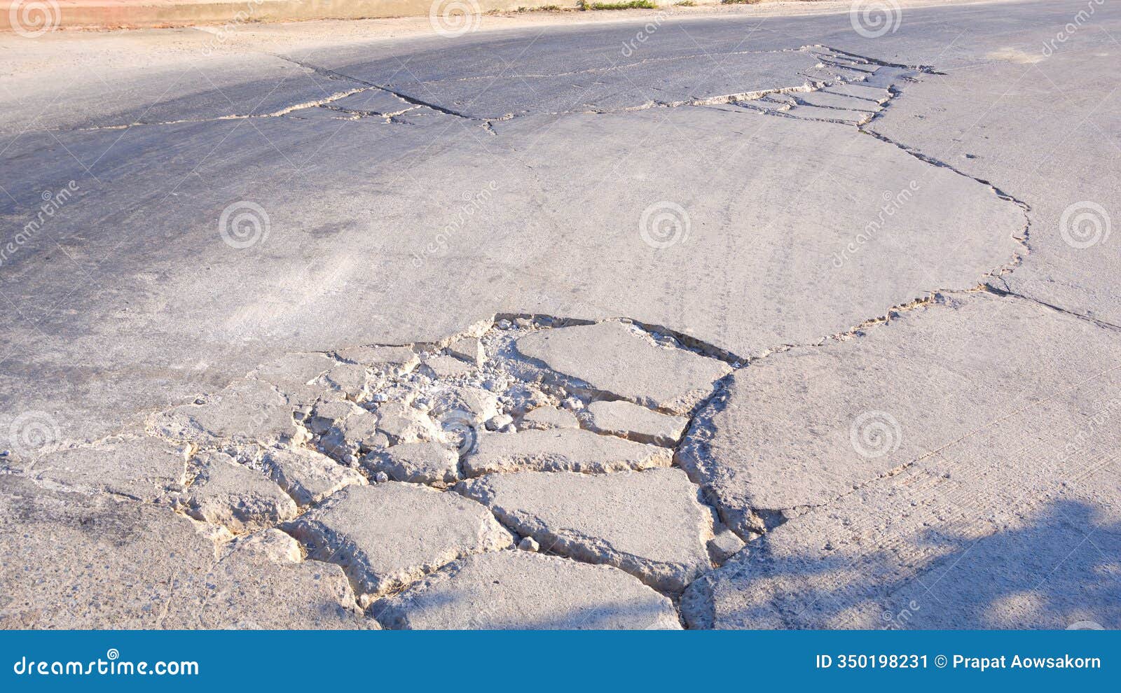 The Old Badly Damaged Curve Concrete Street with Broken Crack Lines and ...