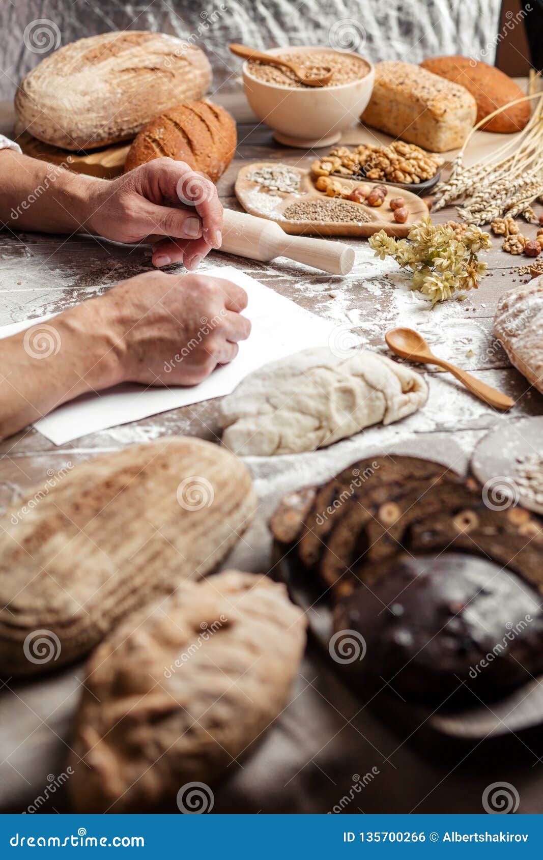Old Baker Writing Down Old-time Recipe in Bakery Notebook Surrounded by ...