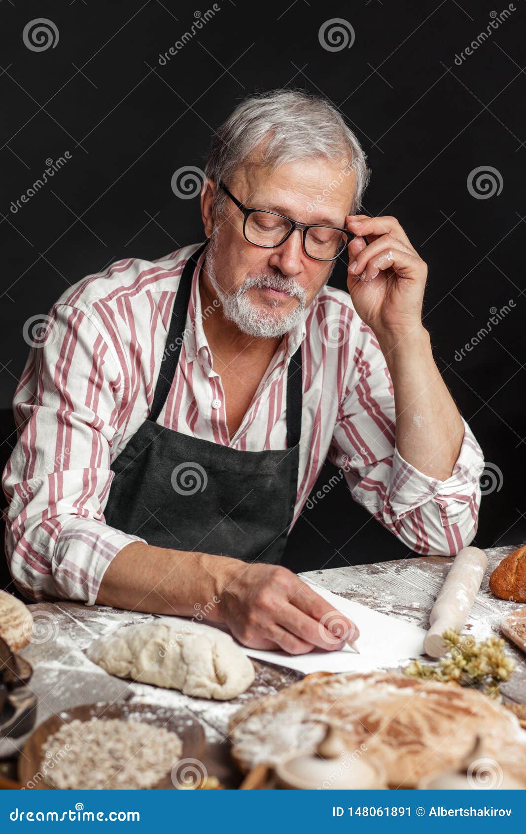 Old Baker Writing Down Old-time Recipe in Bakery Notebook Surrounded by ...