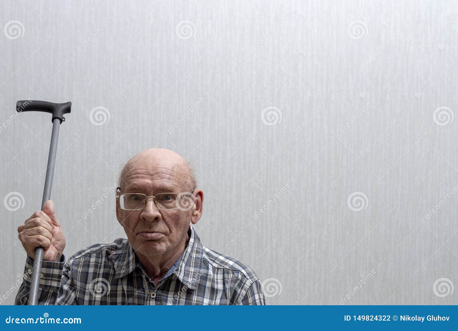 An Old Bald Man with Glasses is Waving a Walking Stick Stock Photo ...