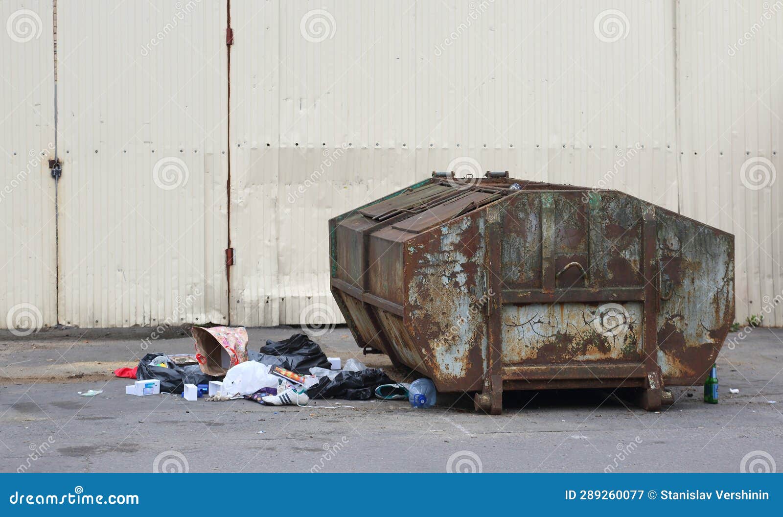 An Old Big Rusty Dumpster Stands Near a Metal Fence Stock Image - Image ...