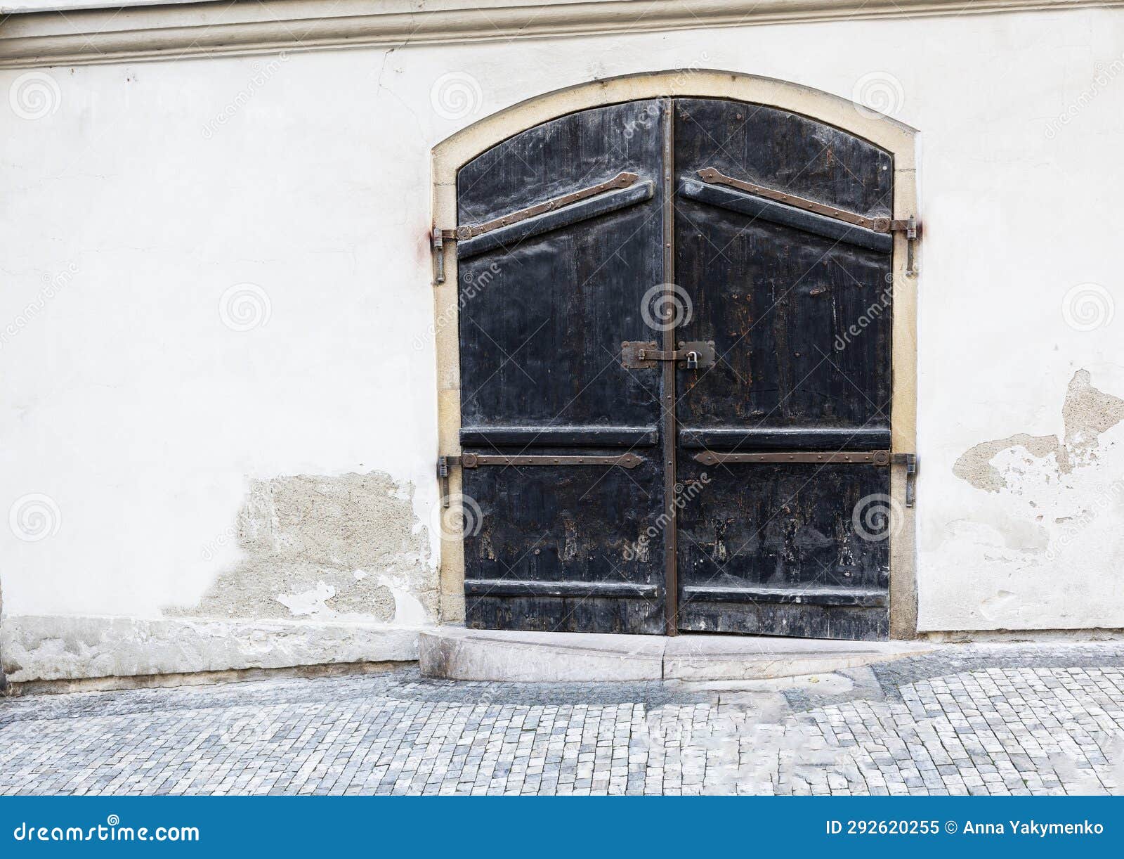 Old Black Wooden Gate with Metal Locks on a Light Wall Stock Image ...