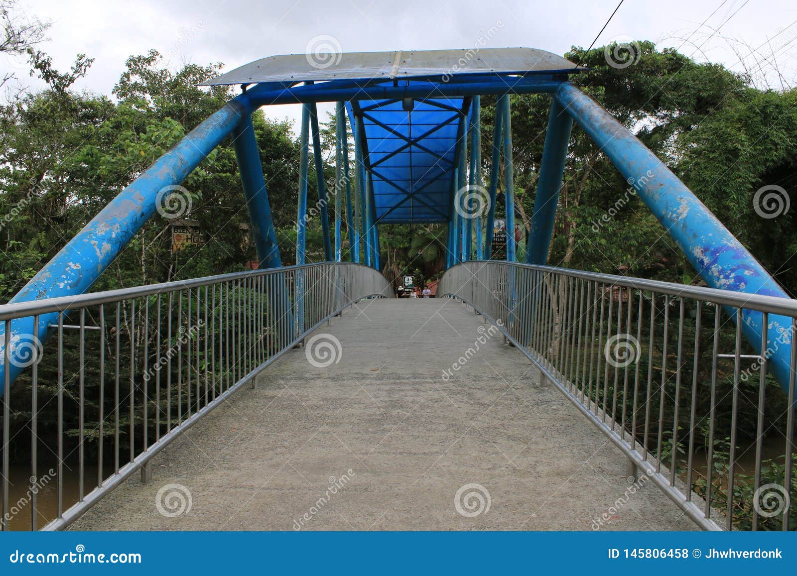 Old Blue Bridge Leading To an Area with Many Trees Stock Photo - Image ...