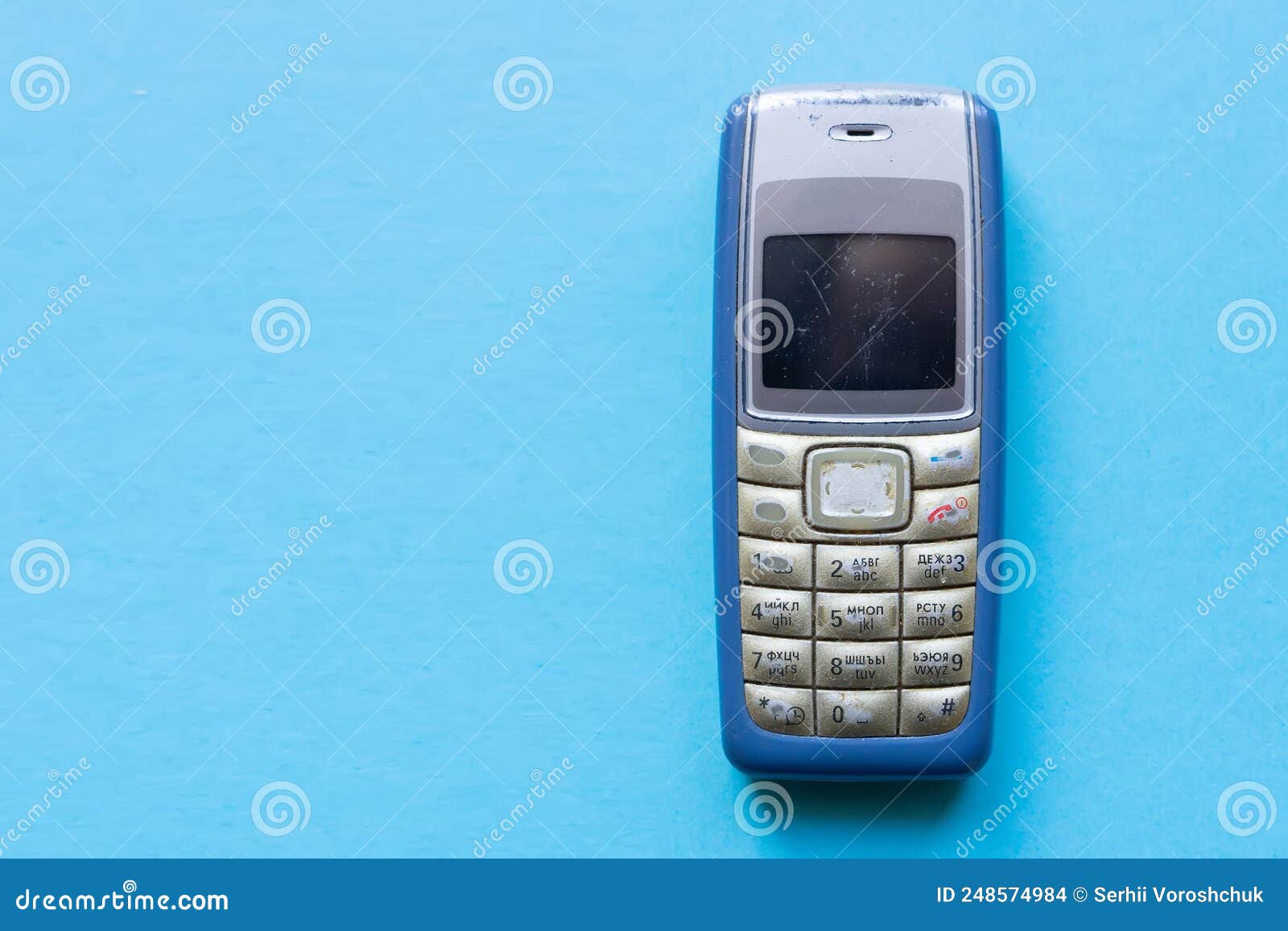 Old Blue Button Mobile Phone on Blue Background Stock Photo - Image of ...