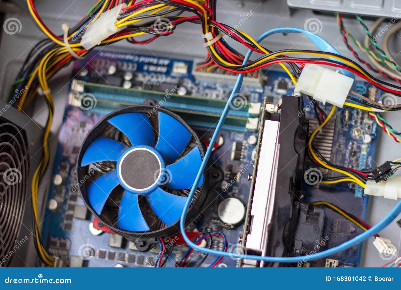 Old Blue Cooler Fan with Motherboard and Colorful Cables Inside a ...