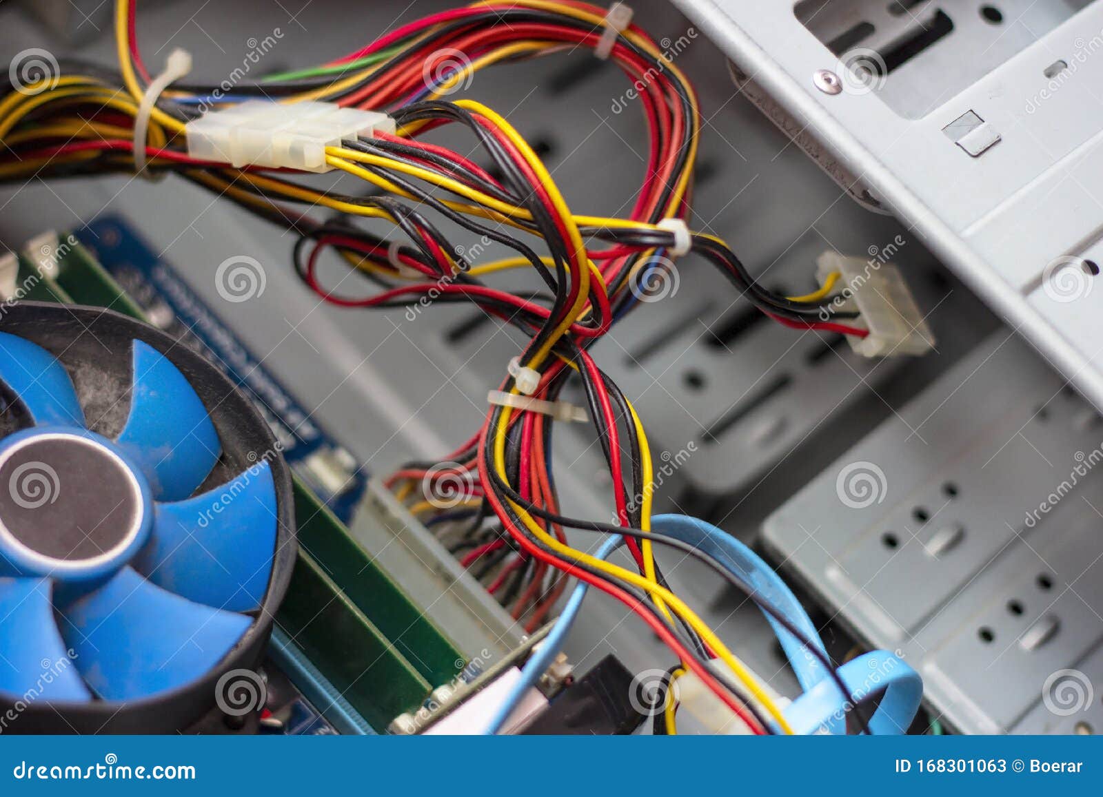 Old Blue Cooler Fan with Motherboard and Colorful Cables Inside a ...