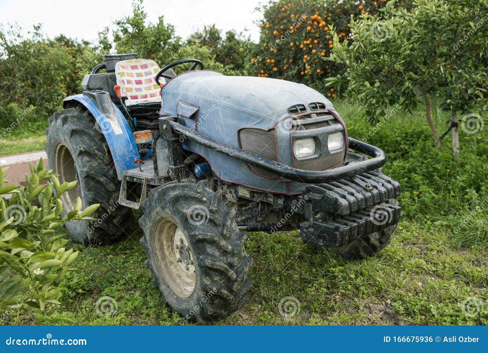 Blue Tractor Equipped With Harrow Working On The Field Editorial Image ...