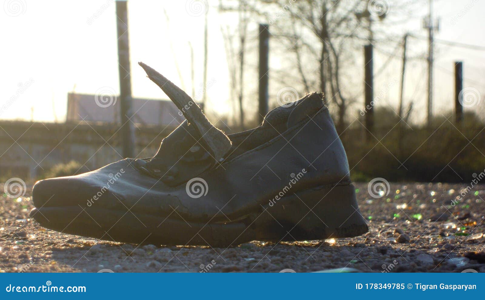 An Old Boot in the Midst of Urban Trash, Lie on the Pavement Under the ...