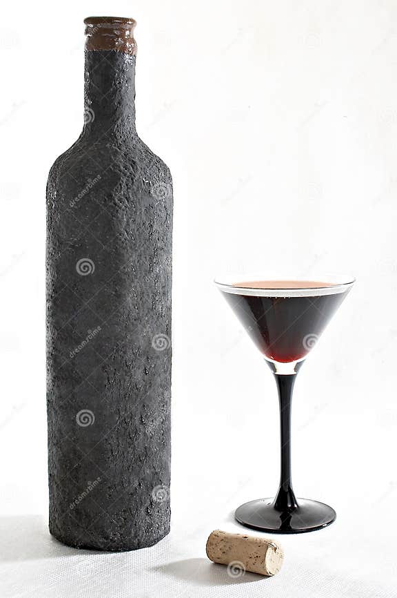 Old Bottle of Wine with a Full Beaker of Wine and Cork Stock Photo ...