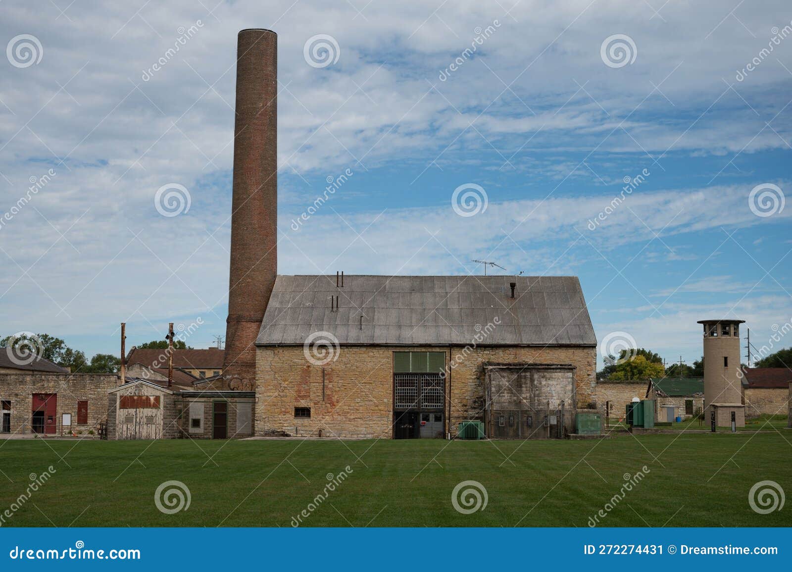 An Old Brick Building with a Very Big Chimney in the Back Stock Image ...