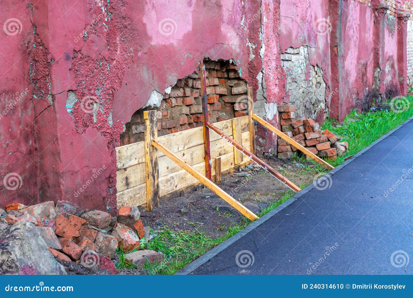 An Old Brick Wall Covered with Plaster is Falling Apart and it is Being ...