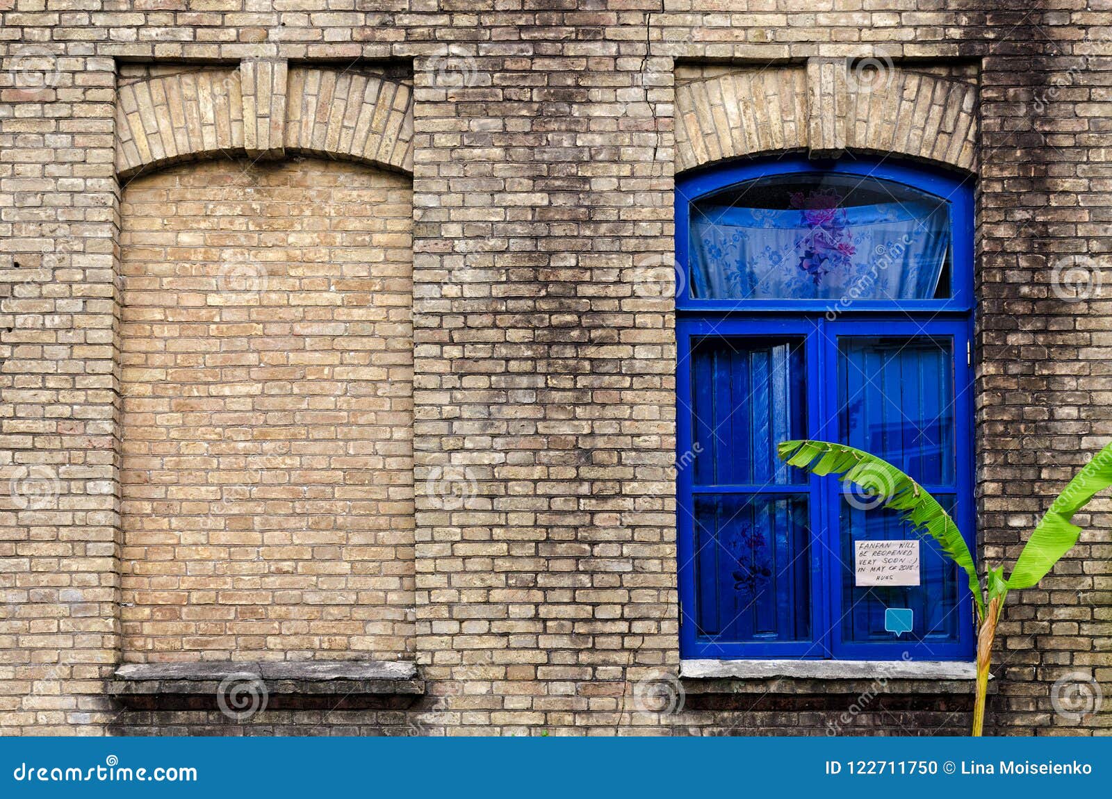 Old Brick Wall with Two Windows, One False, Other with Glass and Blue ...