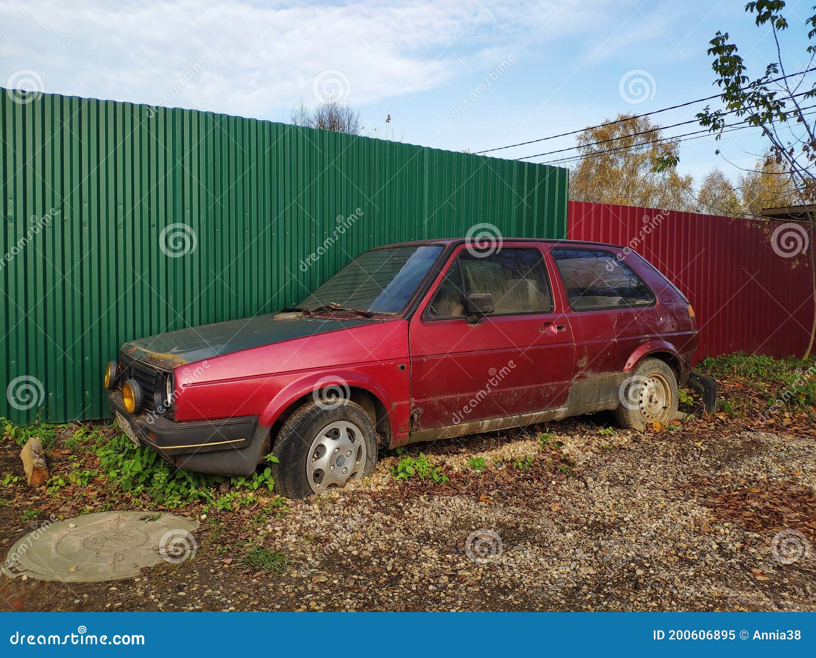 Old Broken Car. Abandoned Rusty Car at the Fence in the Yard Editorial ...