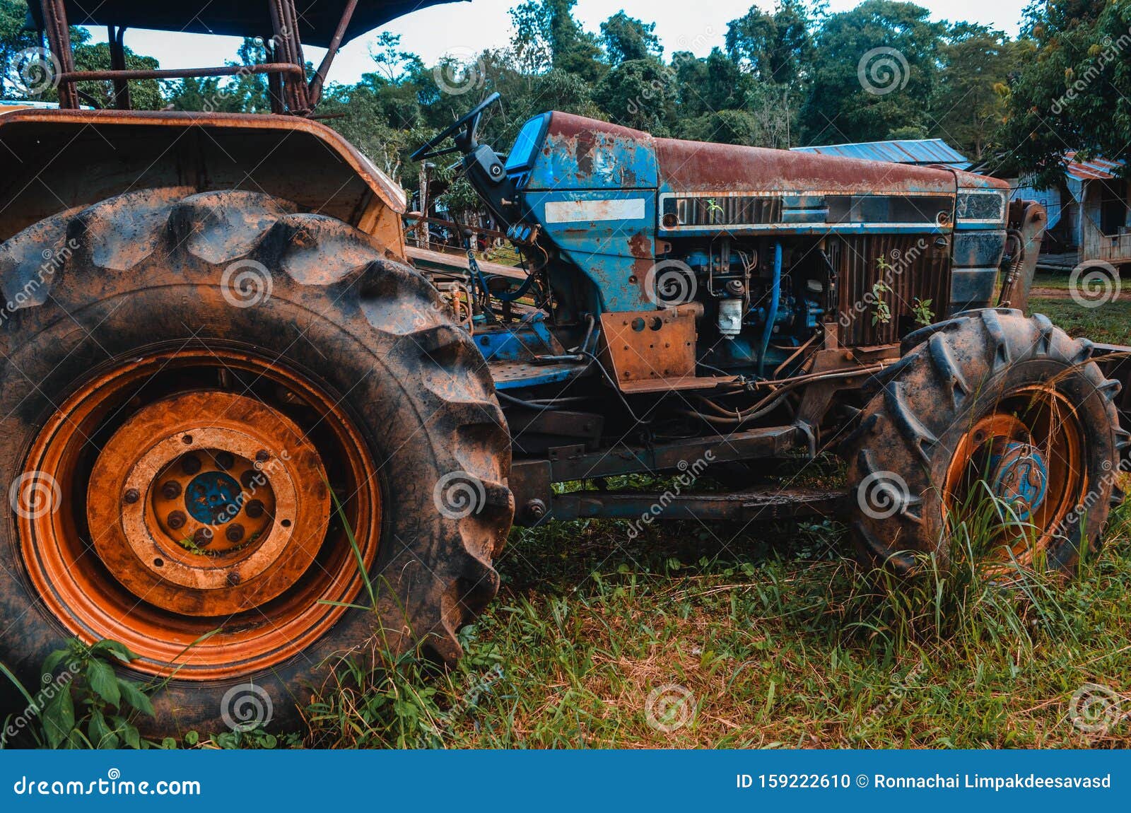 Old Broken Tractor Stands in the Backyard of a Rural House. Stock Photo ...
