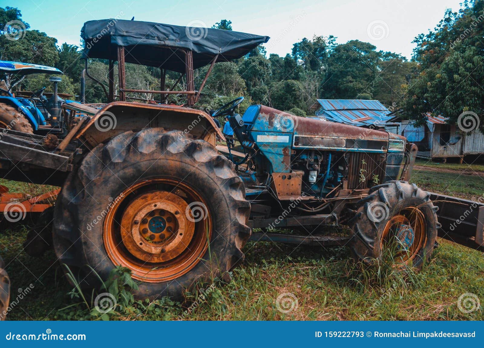 Old Broken Tractor Stands in the Backyard of a Rural House. Stock Image ...