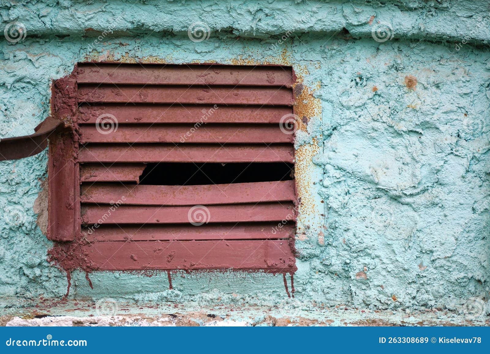 Old Brown Metal Grating with a Broken Compartment in a Concrete Wall ...