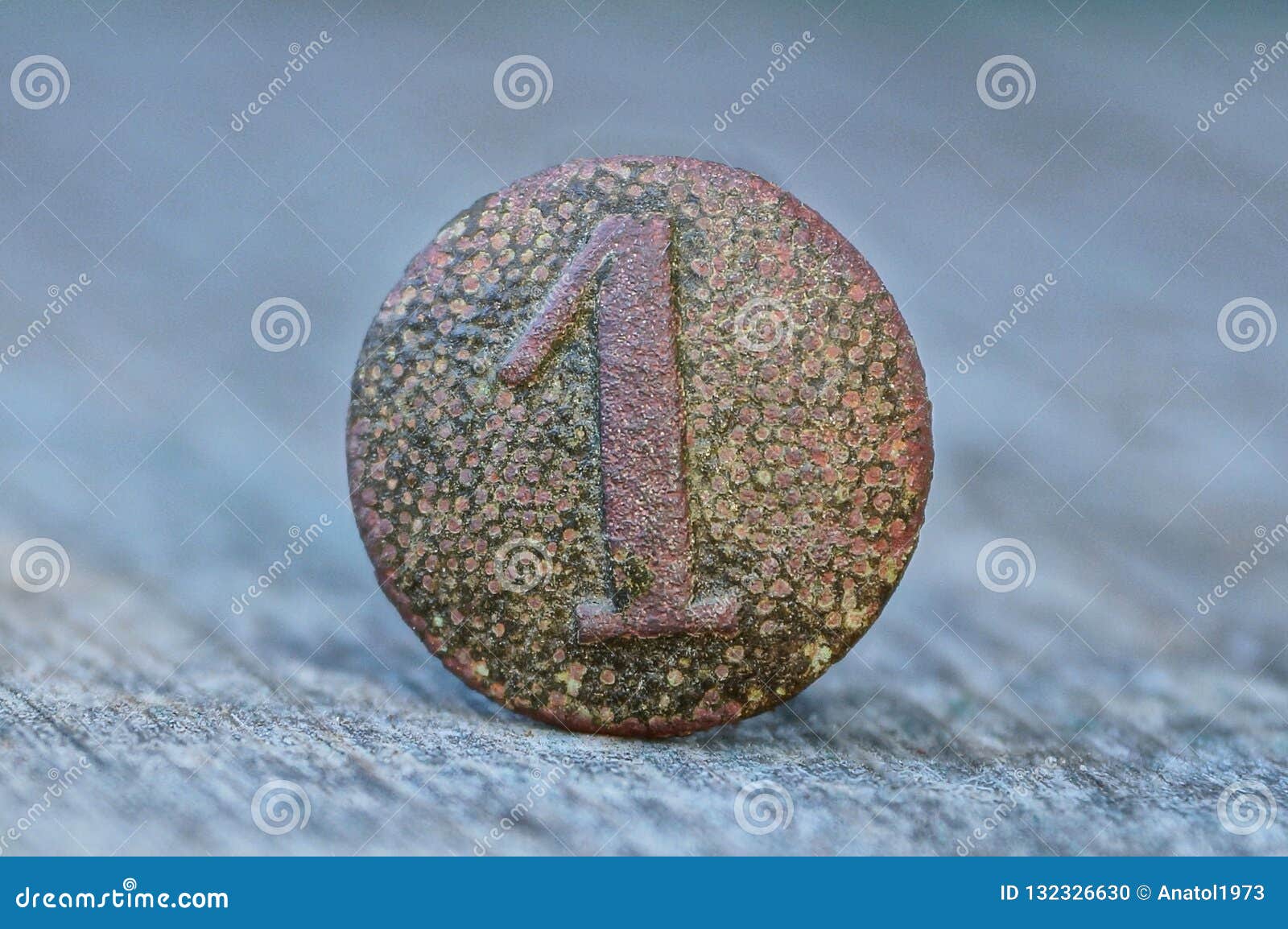 Old Brown Rusty Button with Number One on Gray Table Stock Photo ...