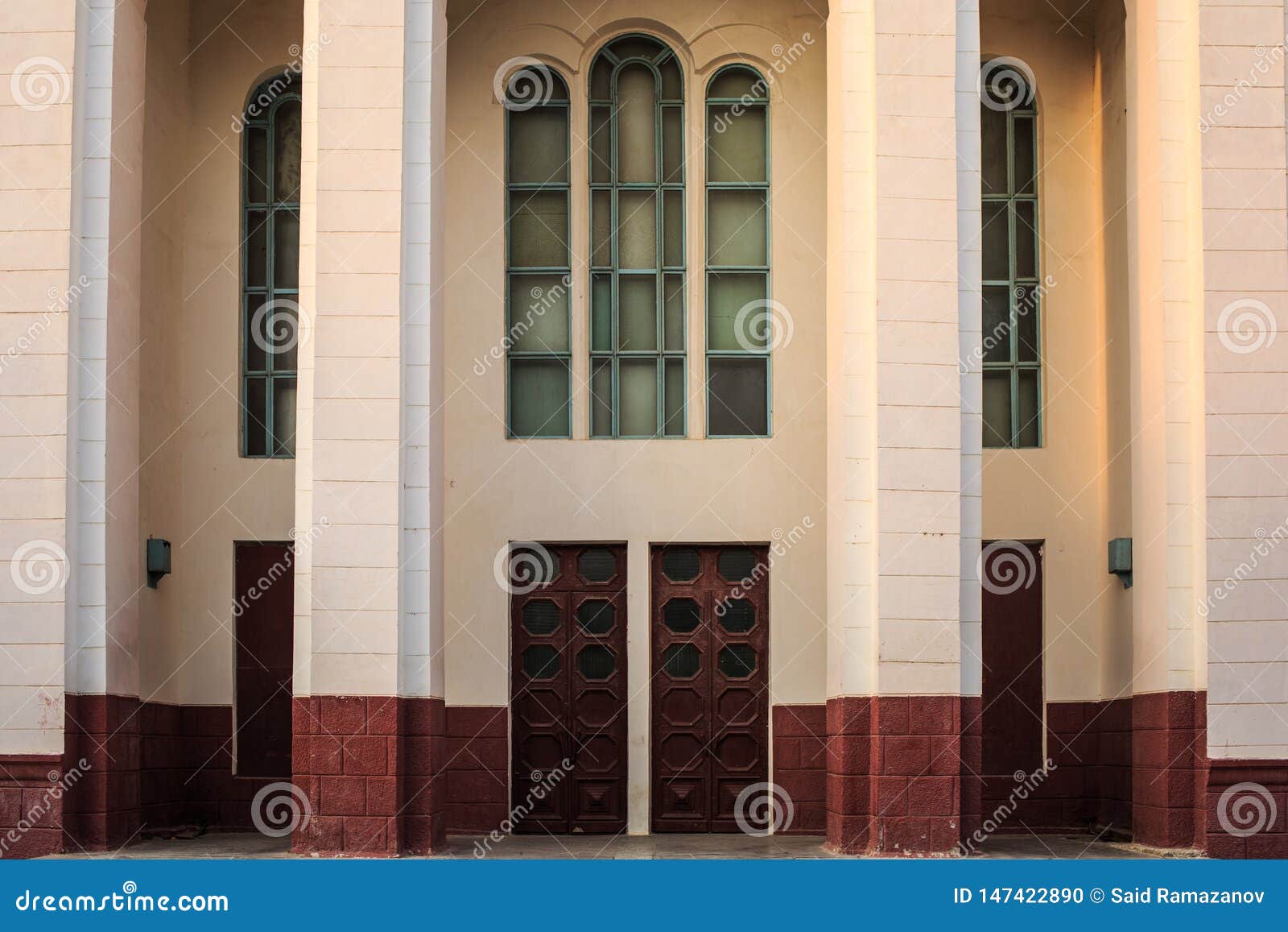 Old Building in Beige and Maroon Colors with High Windows and Doors ...