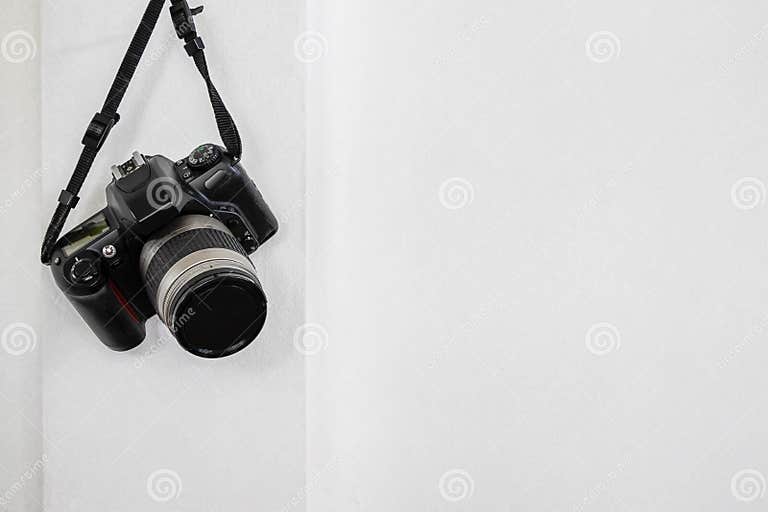 Camera Hanging on White Concrete Wall Background Stock Image - Image of ...