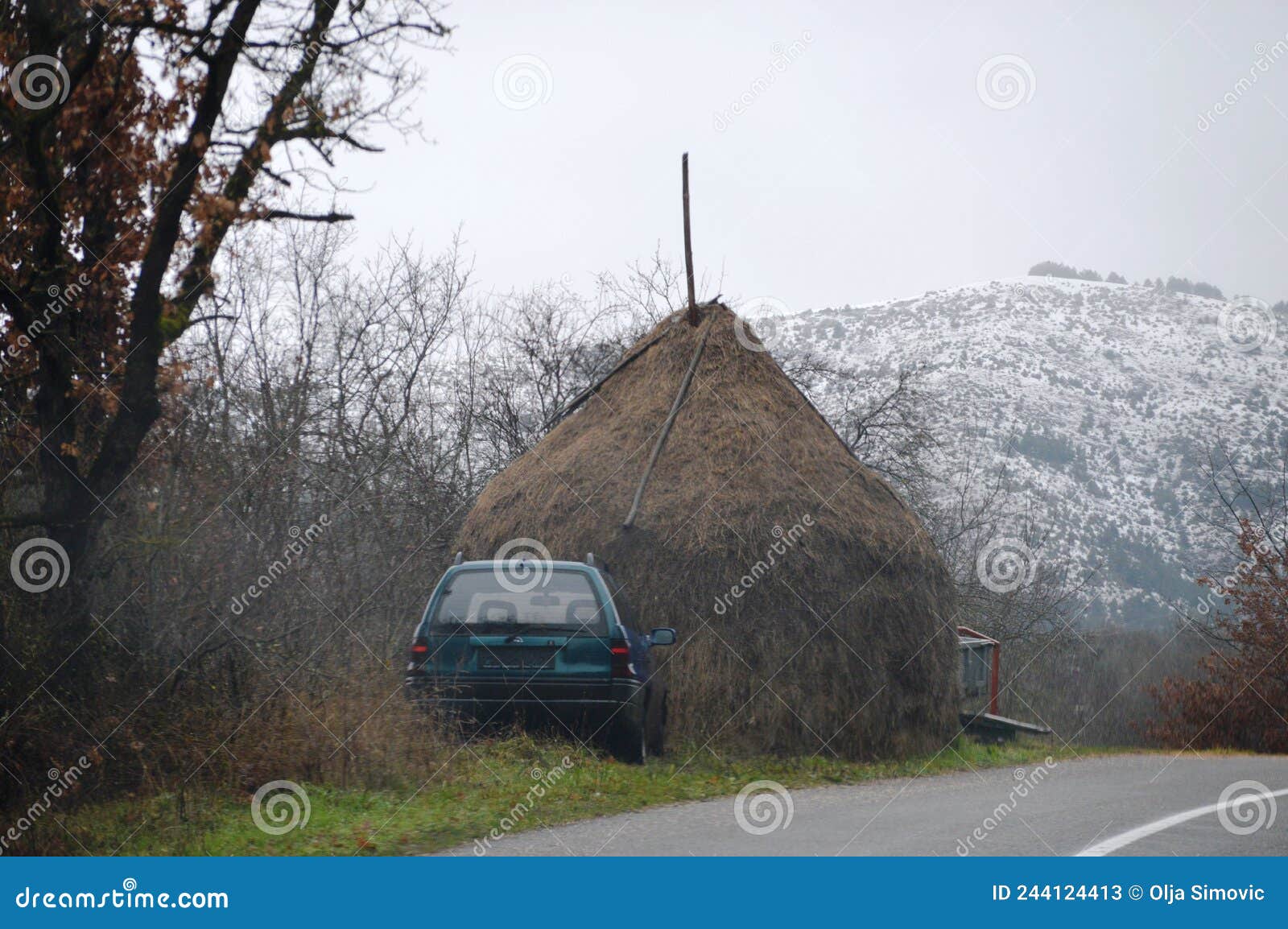 Car parked next to the hay stock image. Image of hill - 244124413