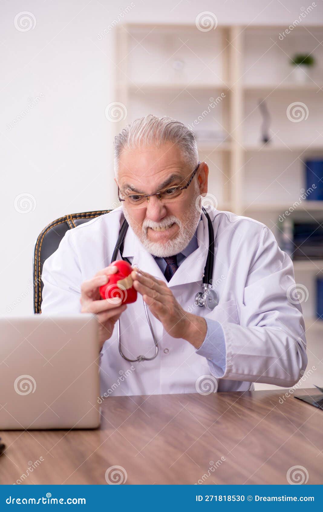 Old Male Cardiologist Holding Heart Model Stock Photo - Image of ...