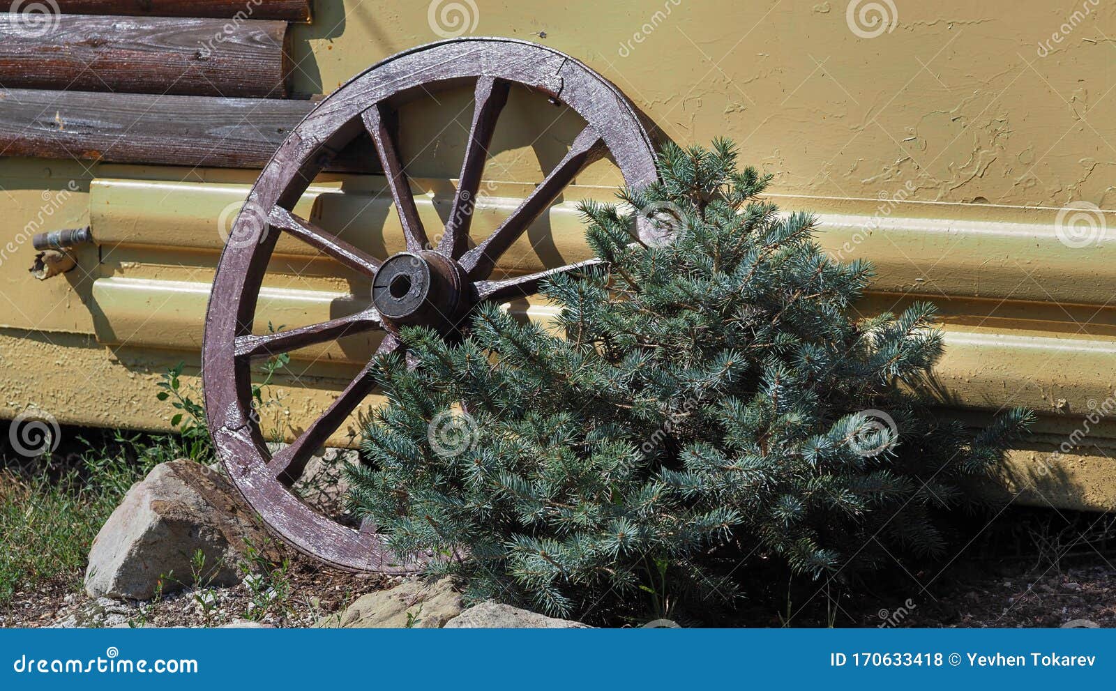 An Old Cart Wheel Near the Barn Stock Photo - Image of landscaping ...