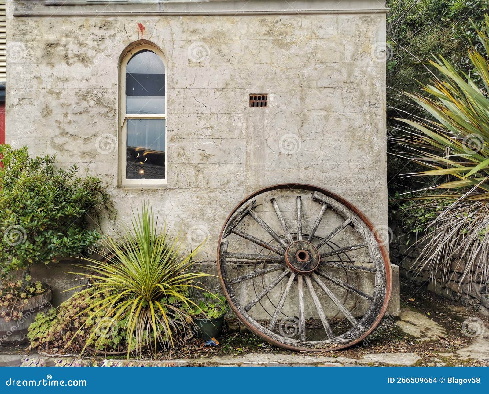 Old Cart Wheel by a Stone Garden Wall Stock Photo - Image of stone ...