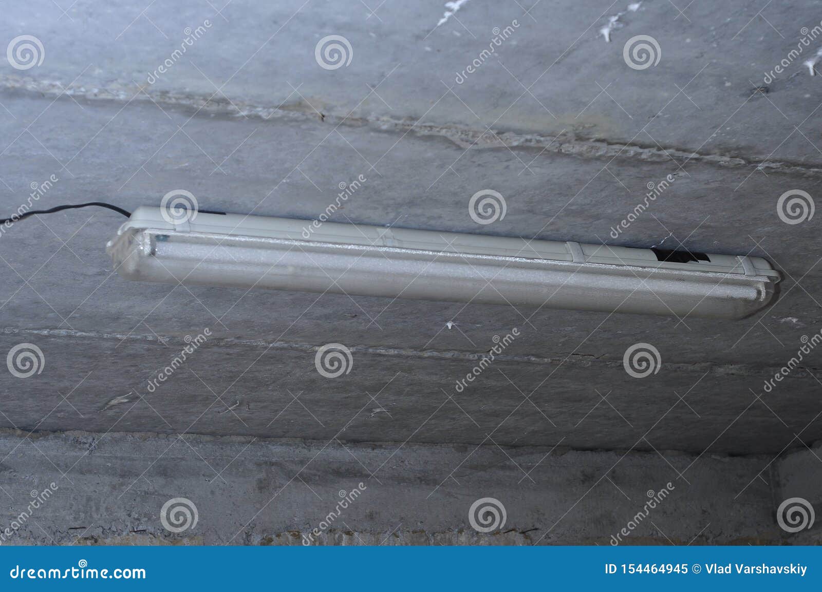 Old Ceiling Lamp with Long Lamps in the Basement on the Concrete ...