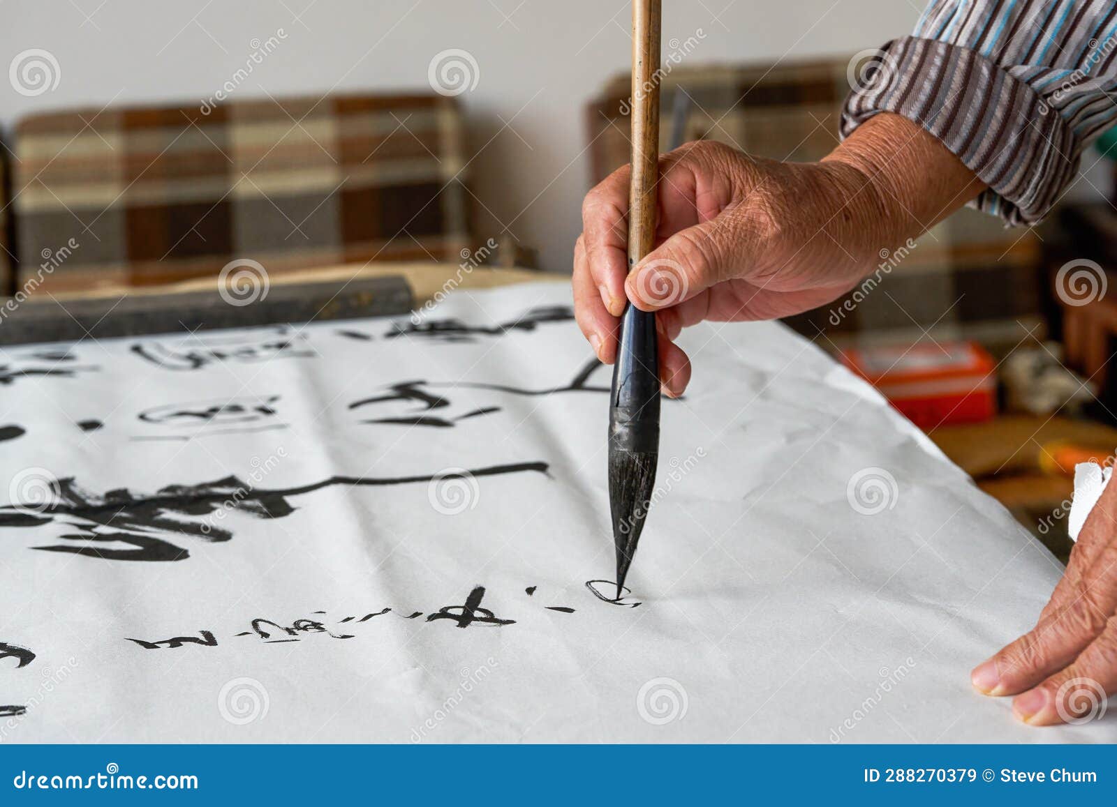 An Old Chinese Calligrapher is Writing Calligraphy Characters, Creating ...