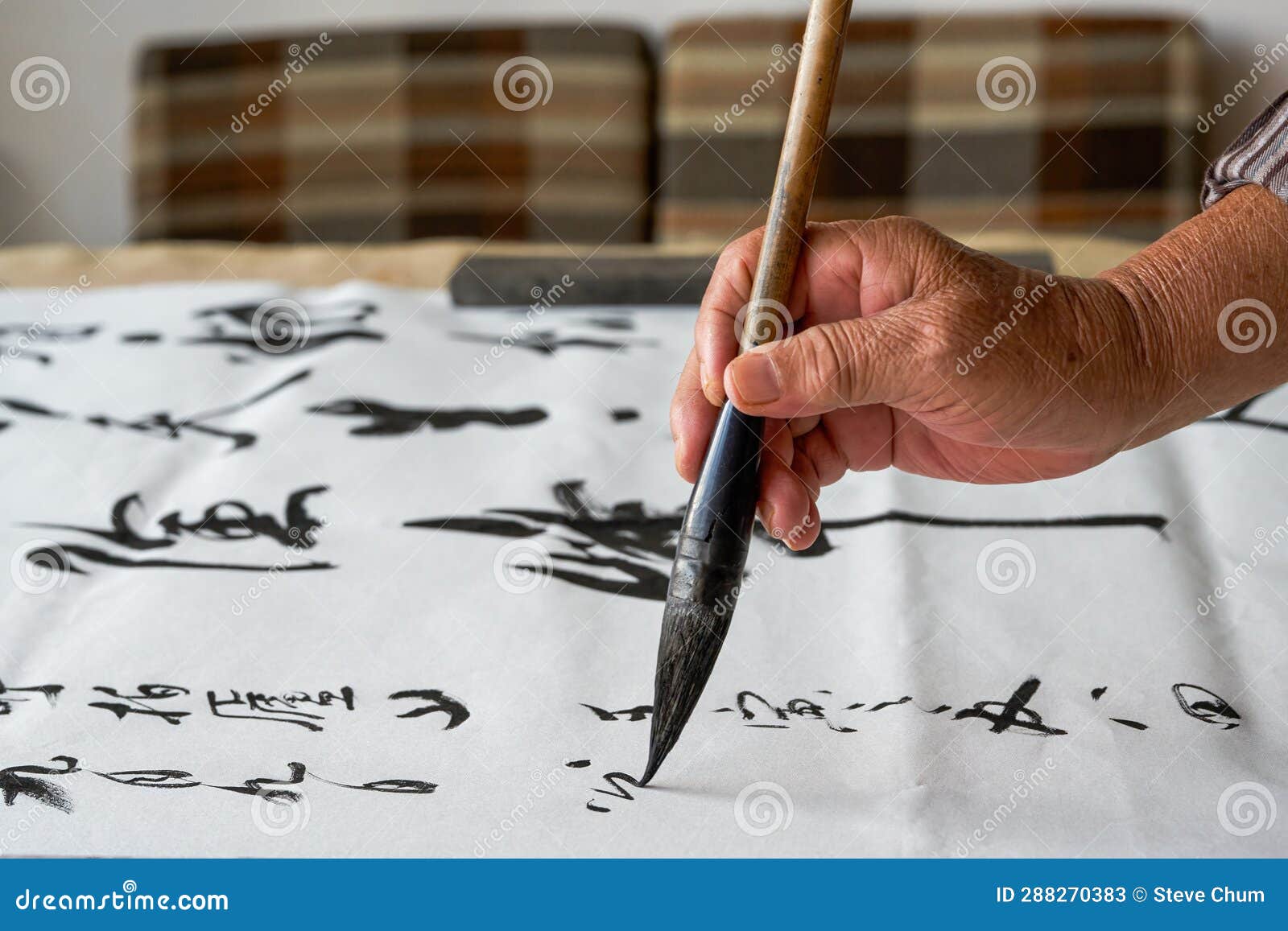 An Old Chinese Calligrapher is Writing Calligraphy Characters, Creating ...
